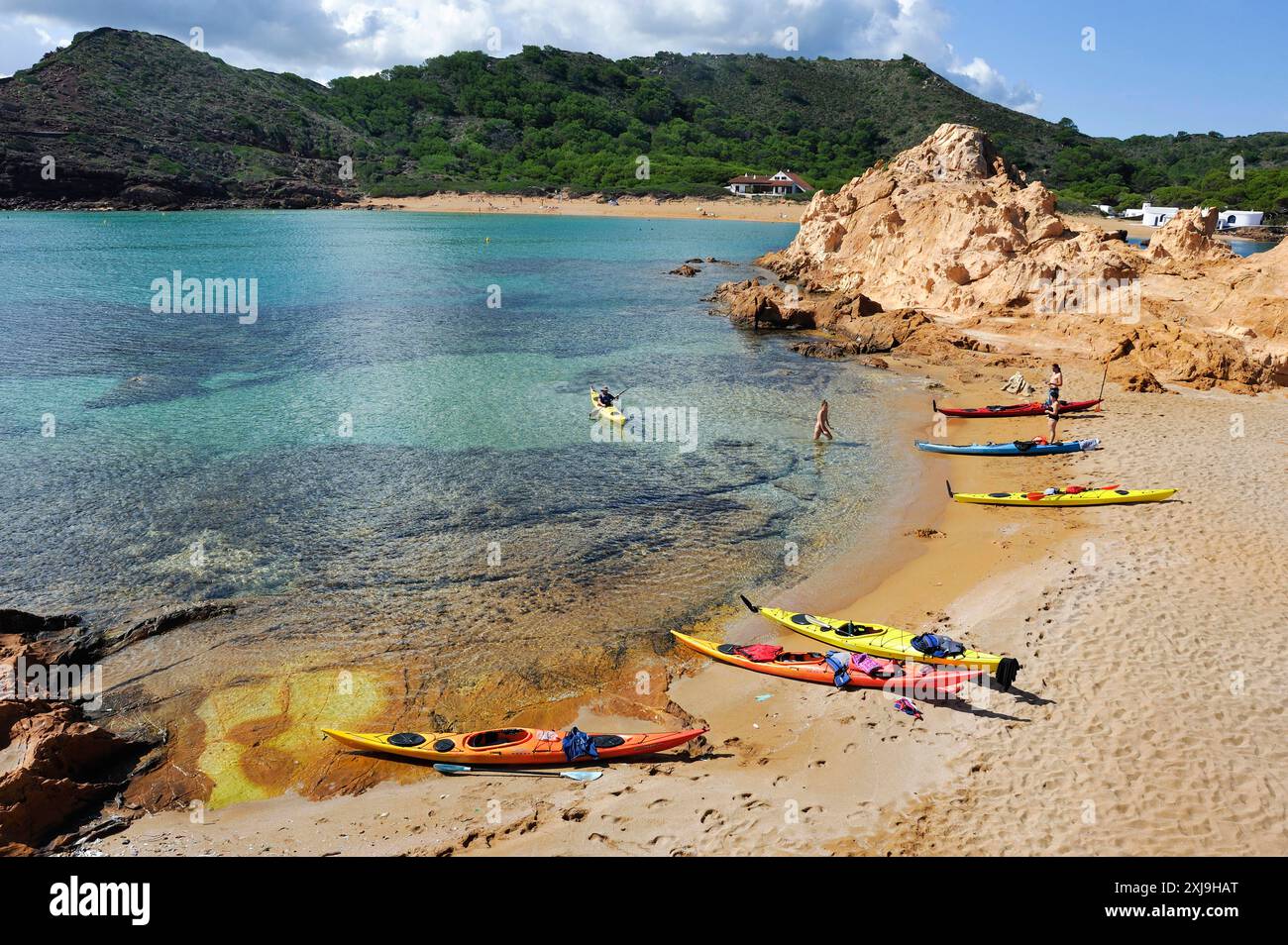 Kayaks landing on an islet in the inlet Cala Pregonda near Cape ...