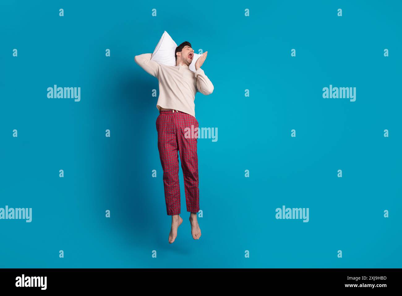 Full length photo of handsome young guy flying yawning dressed ...