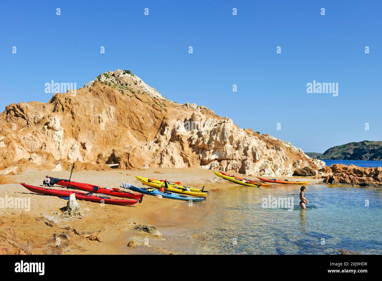Kayaks landed on an islet in the inlet Cala Pregonda near Cape ...