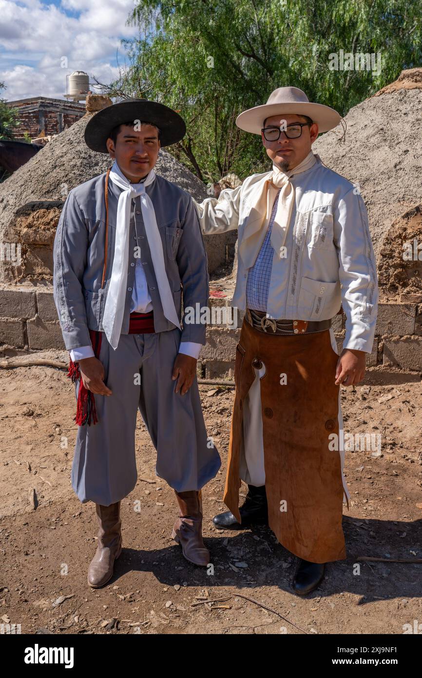 Two young gauchos in their traditional outfits, including the bombacha ...