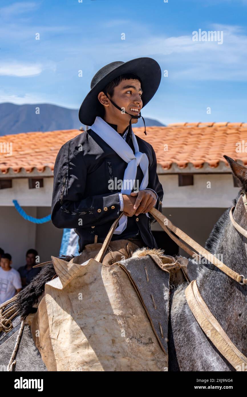 A young Argentine gaucho in his traditional outfit on horseback in ...