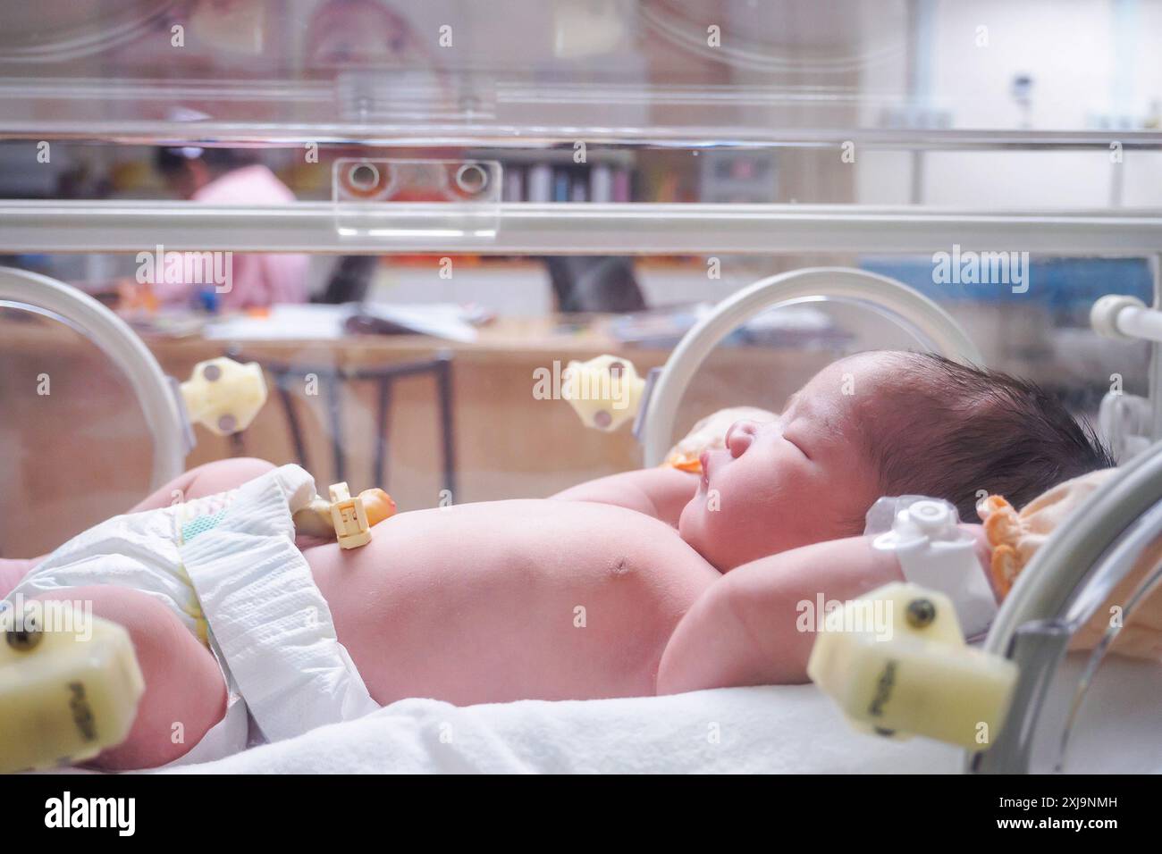 Newborn baby girl inside incubator in hospital post delivery room Stock ...