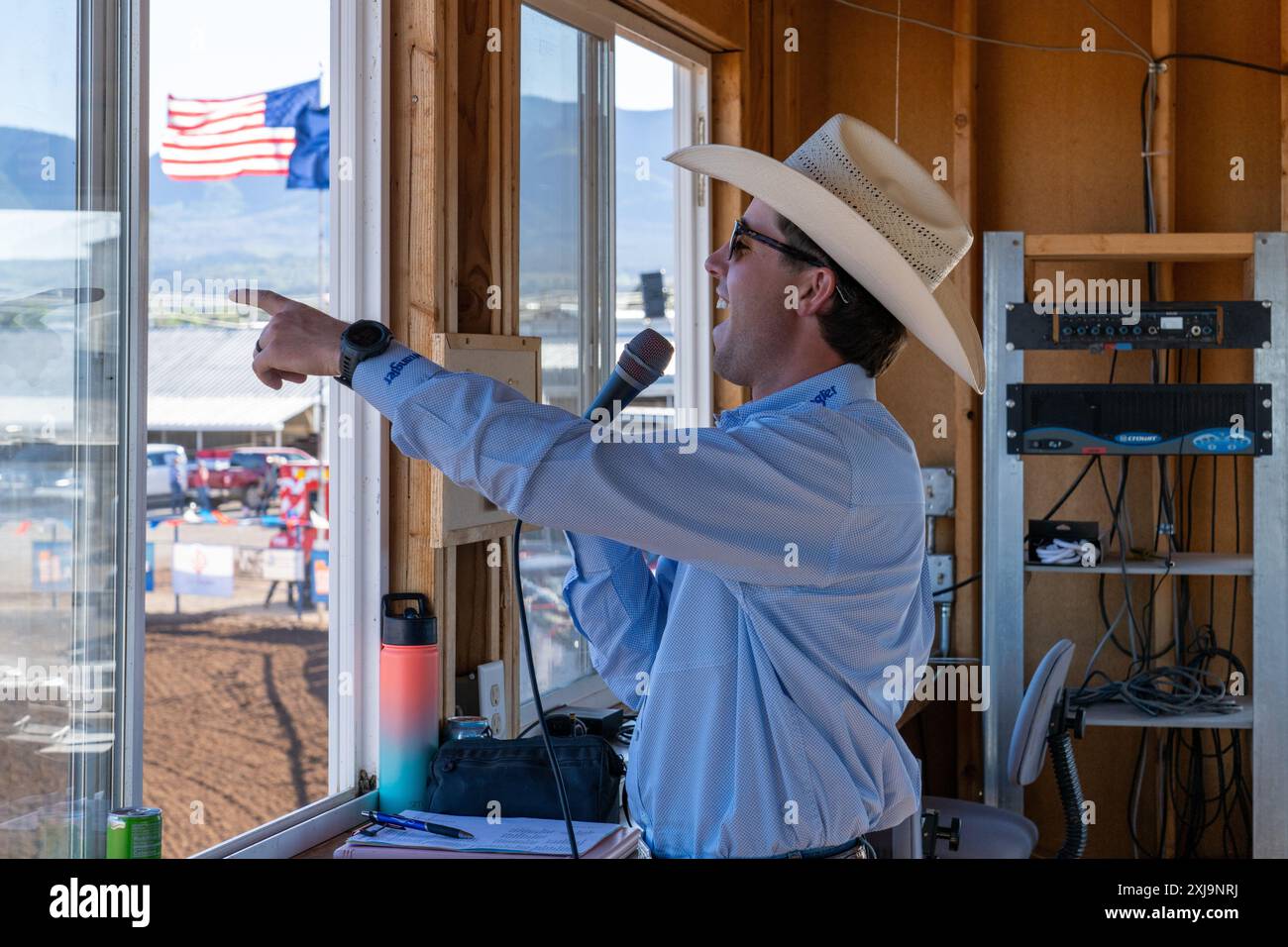 The rodeo announcer in the booth at a rodeo in a small town in rural ...
