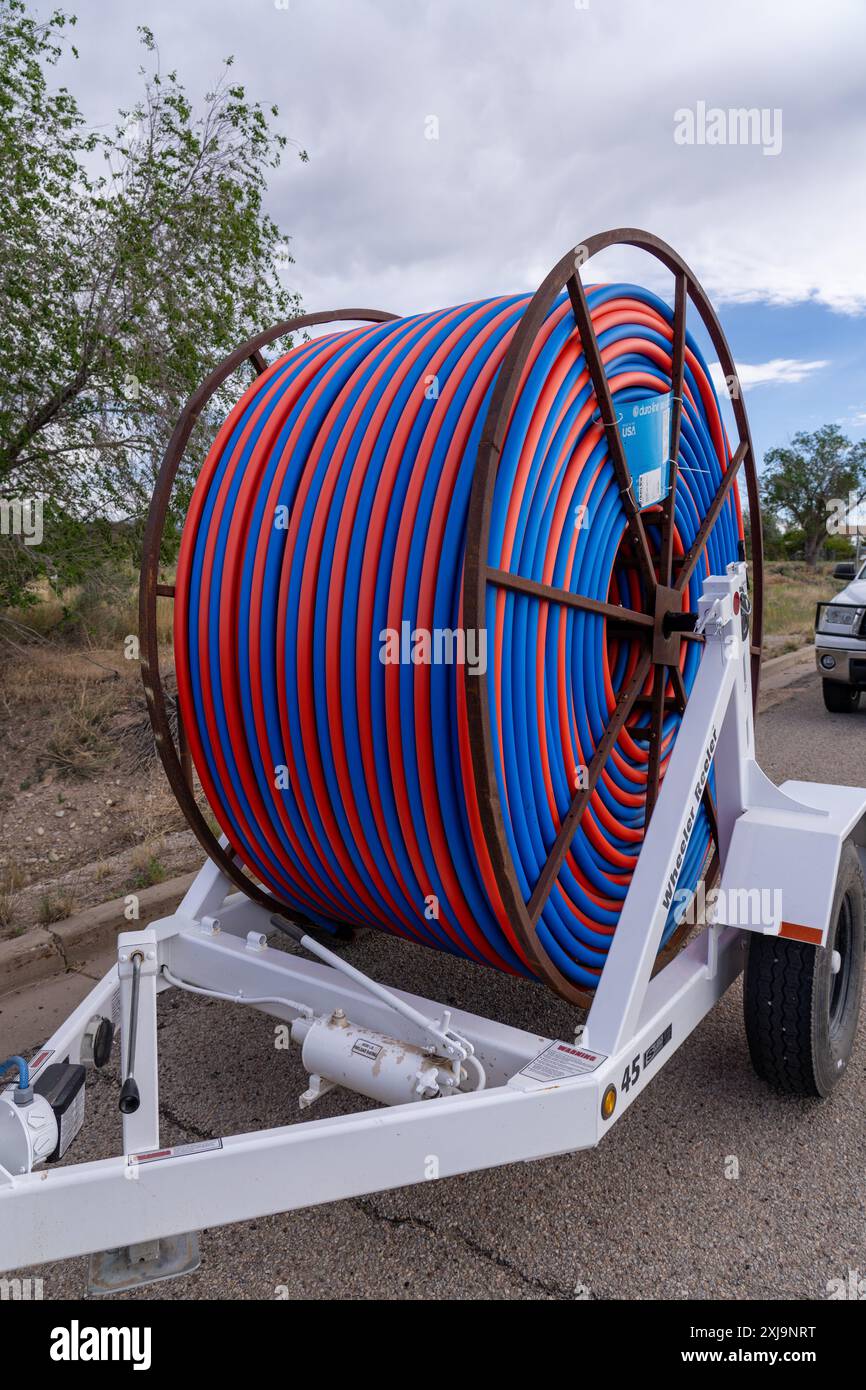 A spool of plastic conduit for internet fiber optic cable being ...