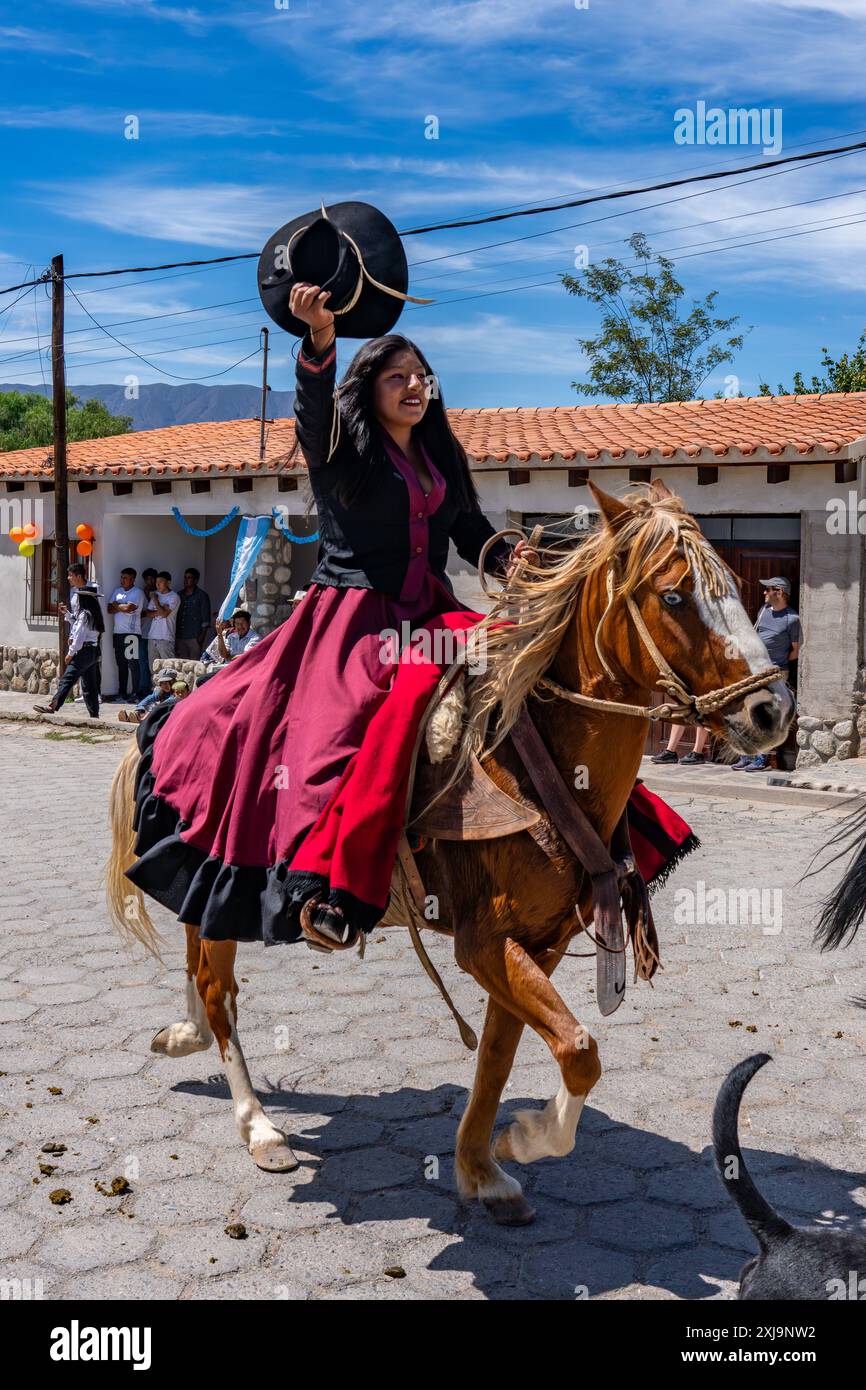A female gaucho in traditional dress in a parade in Cachi, Argentina ...
