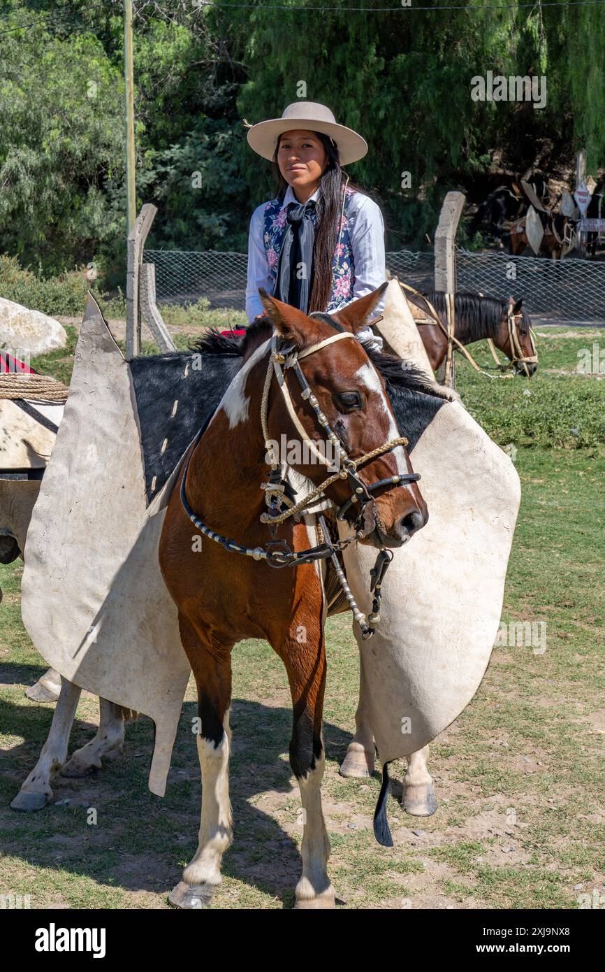 A female gaucho riding with guardamontes, cowhide protection from thorn ...