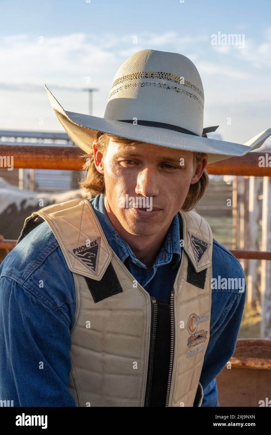 A saddle bronc rodeo cowboy gets ready for his upcoming ride in a rodeo ...