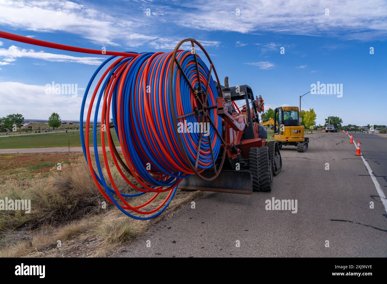 A spool of plastic conduit for internet fiber optic cable being ...