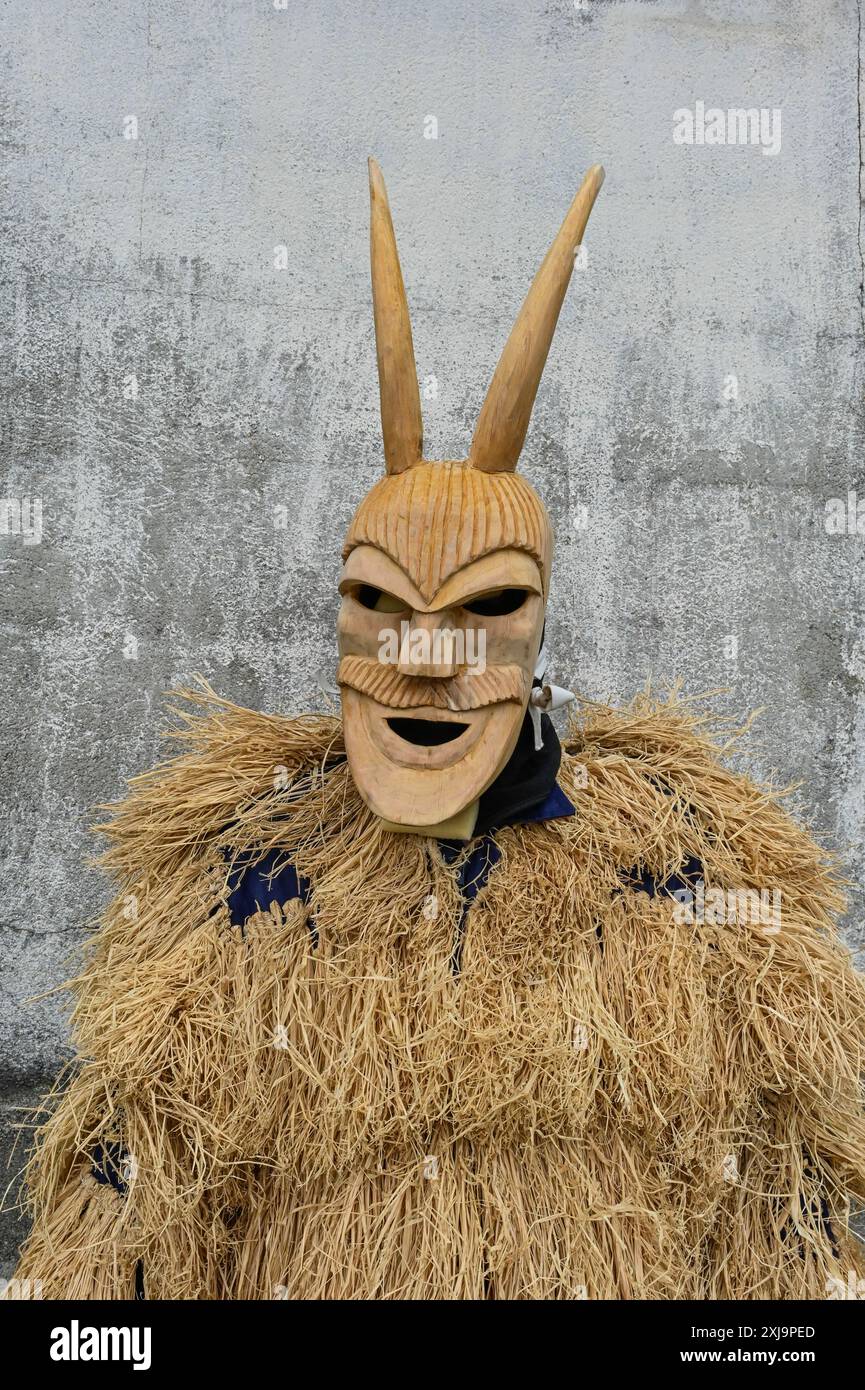 A traditional mask from Lazarim, Portugal, intricately carved from wood ...