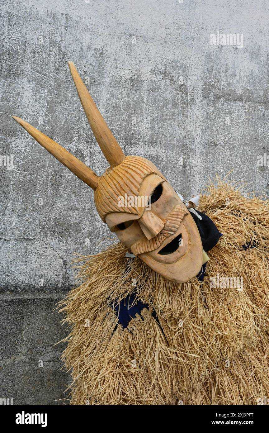 A traditional mask from Lazarim, Portugal, intricately carved from wood ...