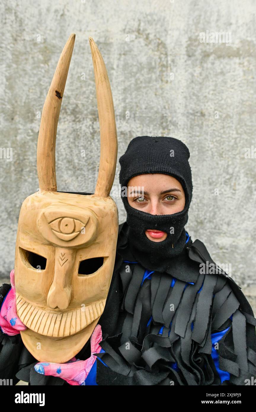 A traditional mask from Lazarim, Portugal, intricately carved from wood ...