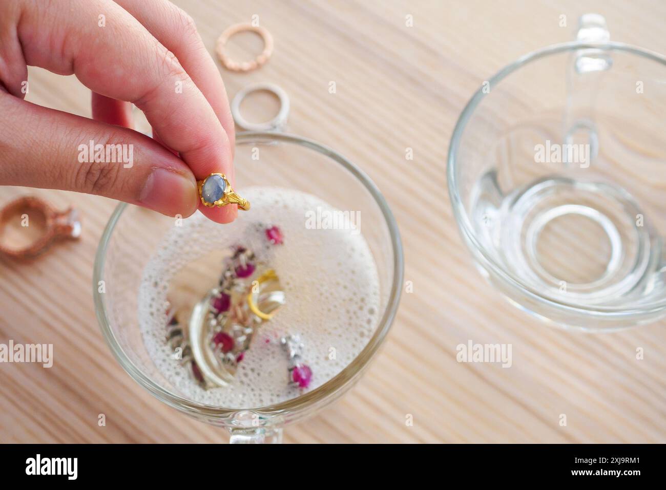 Jeweller hand cleaning vintage gold jewelry ring closeup Stock Photo ...
