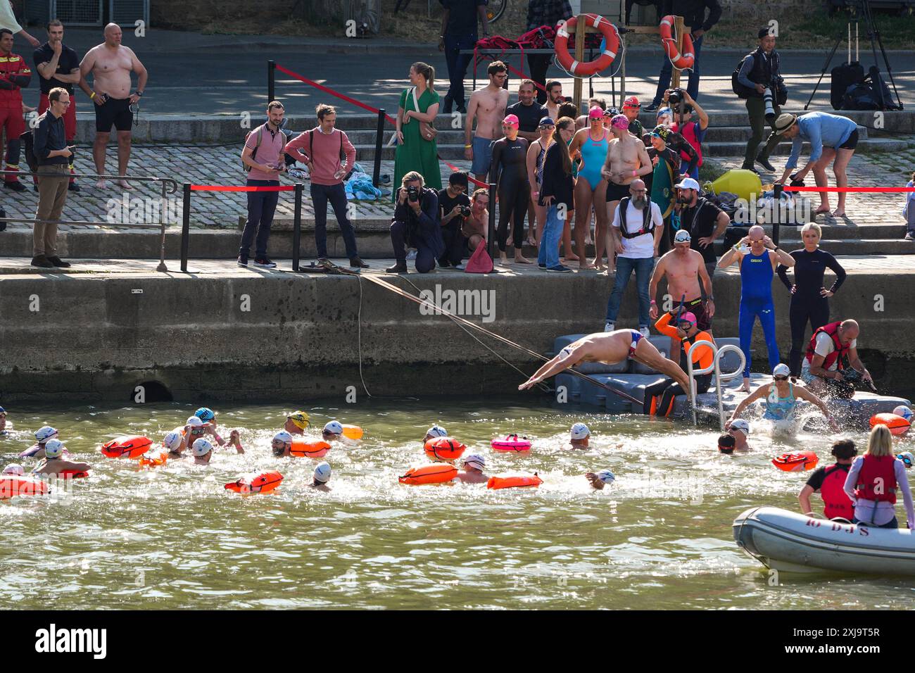 PARIS, July 17, 2024 -- Local residents swim in the Seine River after ...