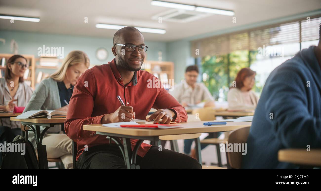 African Man Writing Down Notes in Notebook And Smiling. Group of ...