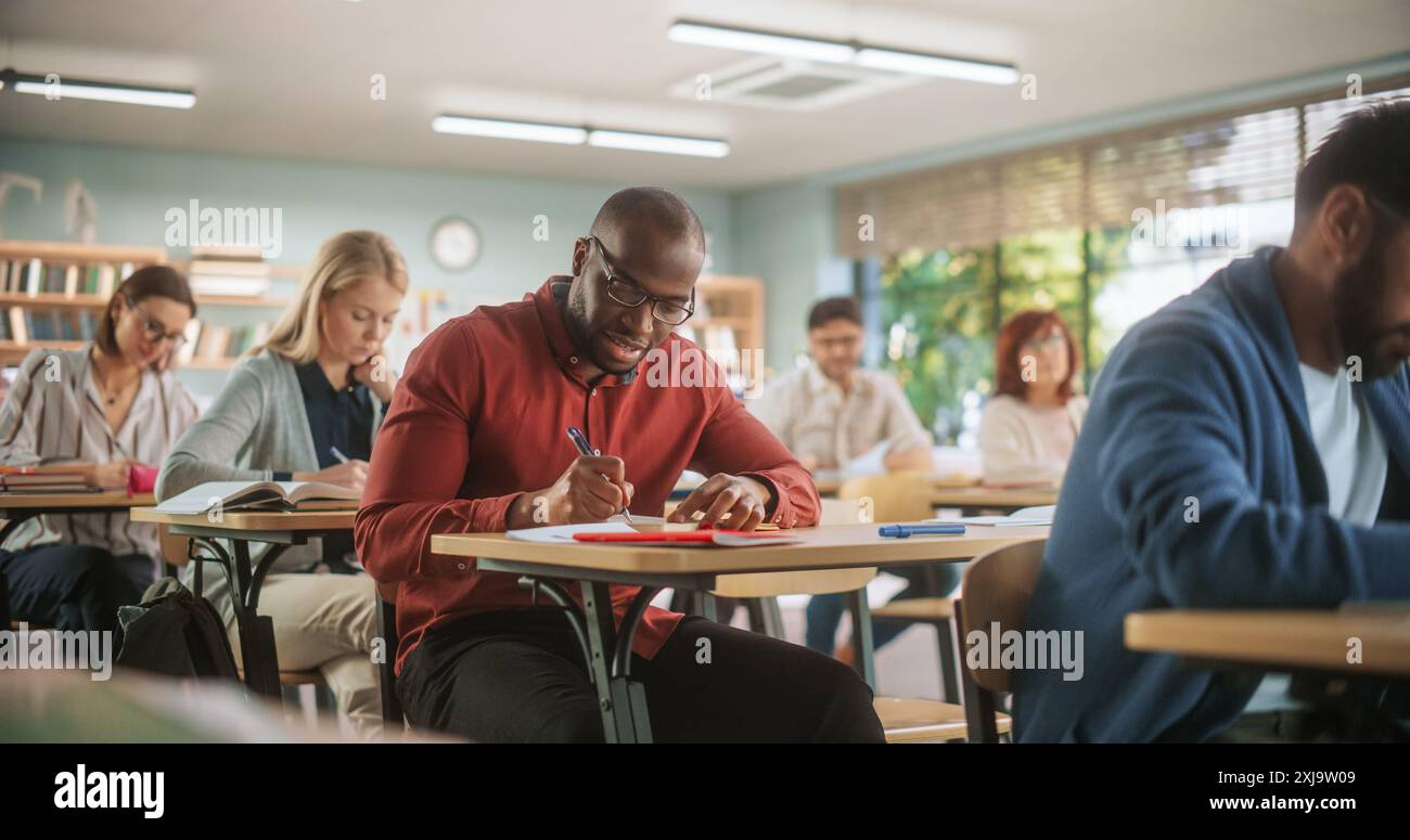 Handsome African Man Writing Down Notes in Notebook. Group of ...