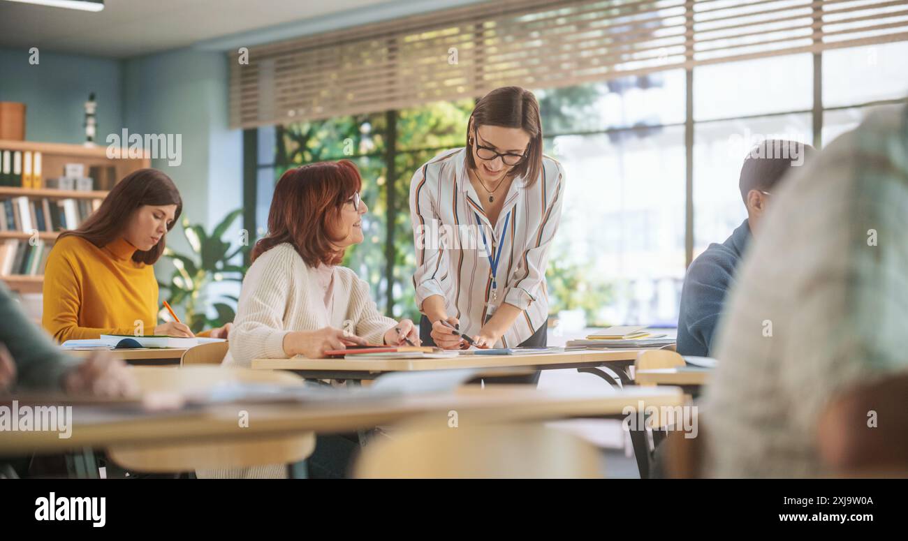 Woman teacher helping elderly hi-res stock photography and images - Alamy