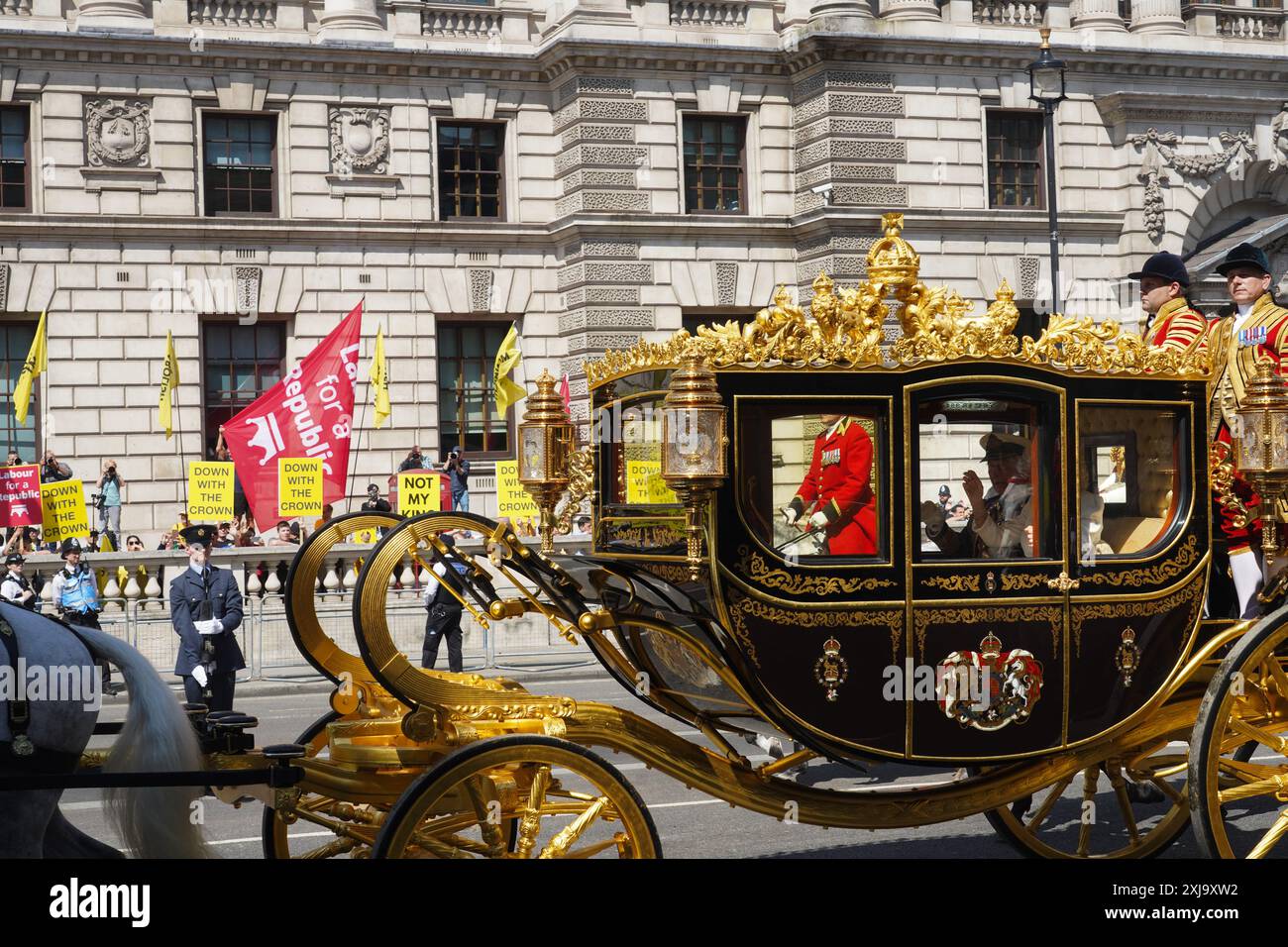 Anti-royalists line the road of Whitehall with banners and placards ...
