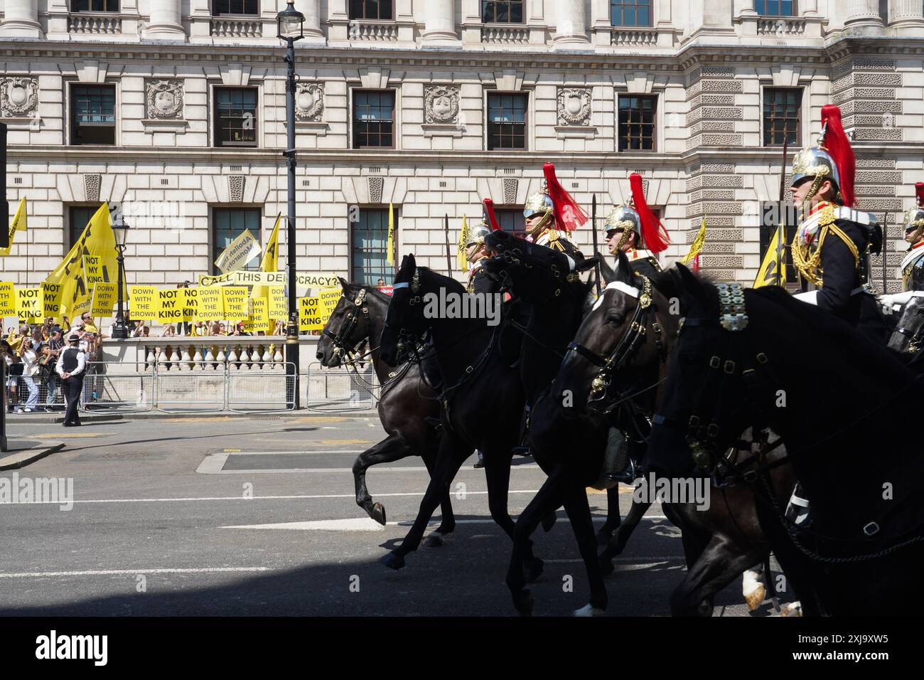 Anti-royalists line the road of Whitehall with banners and placards ...