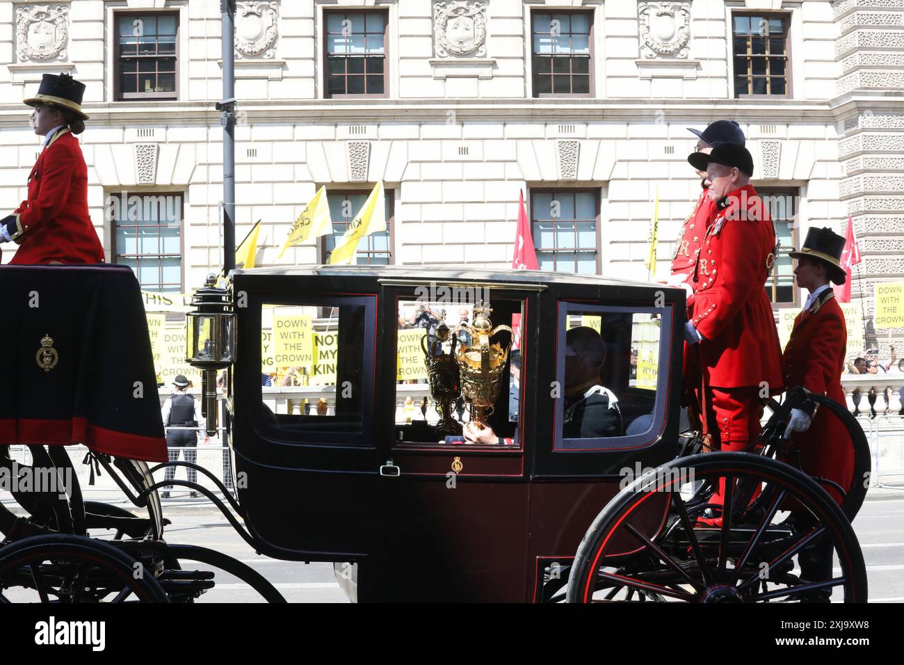 Anti-royalists line the road of Whitehall with banners and placards ...