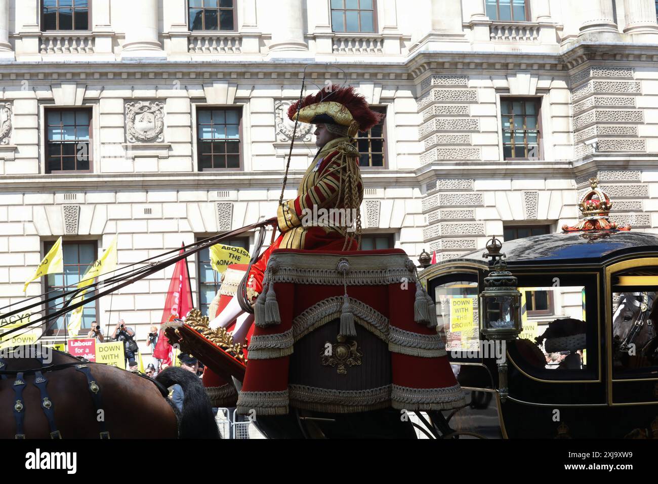 Anti-royalists line the road of Whitehall with banners and placards ...