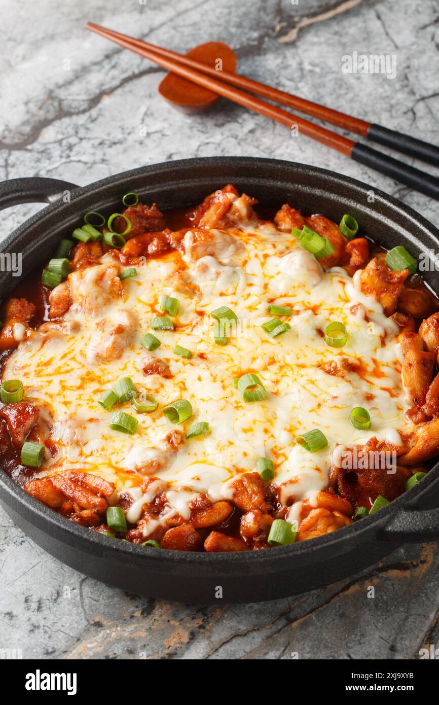 Korean Fire Chicken Cheese Buldak with gochujang paste closeup on the ...