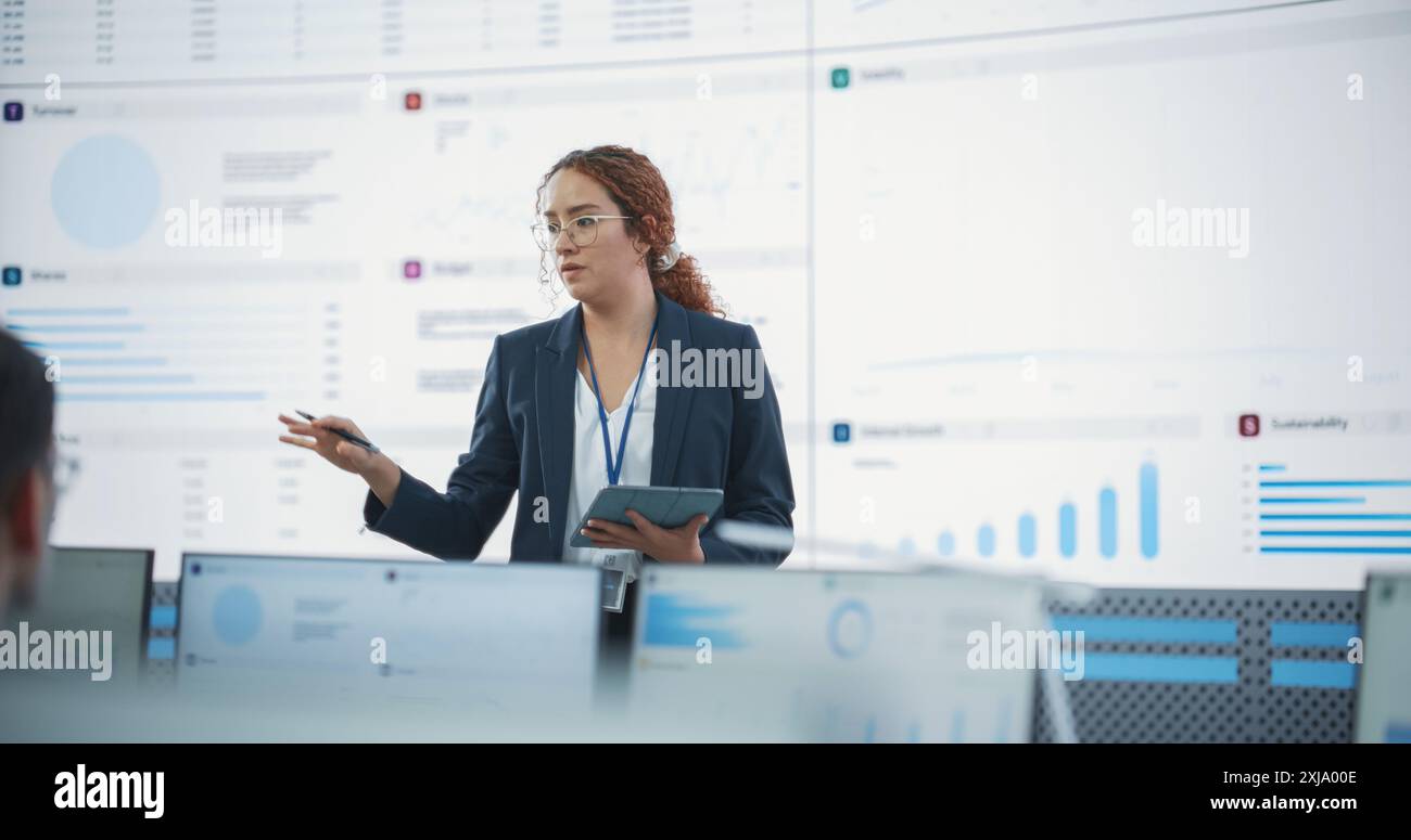 Hispanic Female Senior Data Scientist Reviewing Reports Of Risk ...