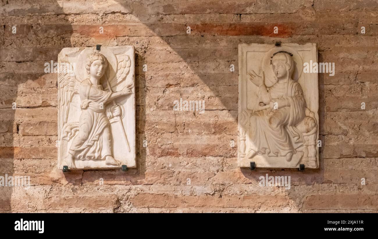 Angel and female catholic saint carved in two separated pieces of ...