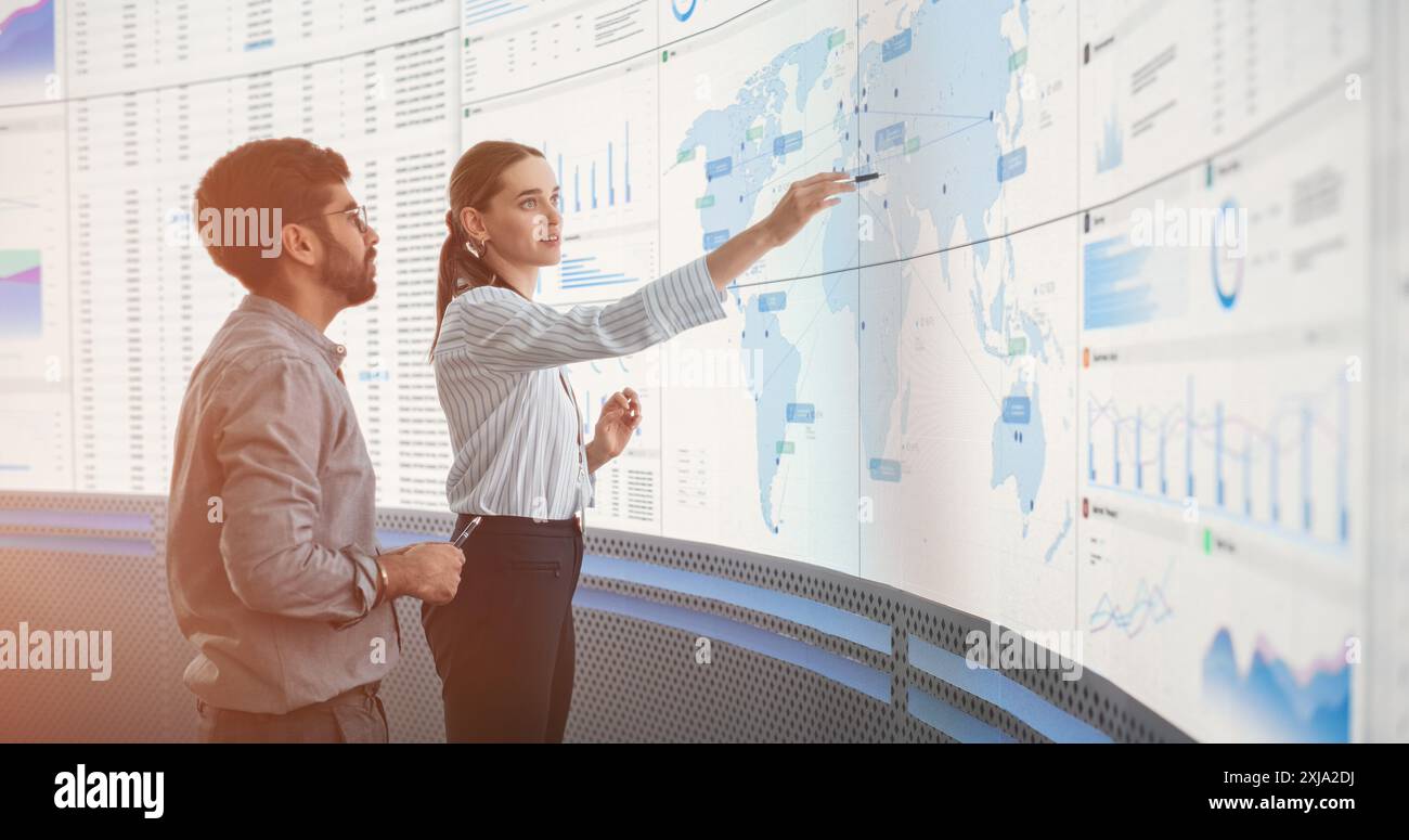 Indian Male Data Scientist And Caucasian Female Business Manager Talking In Front Of Big Digital ...