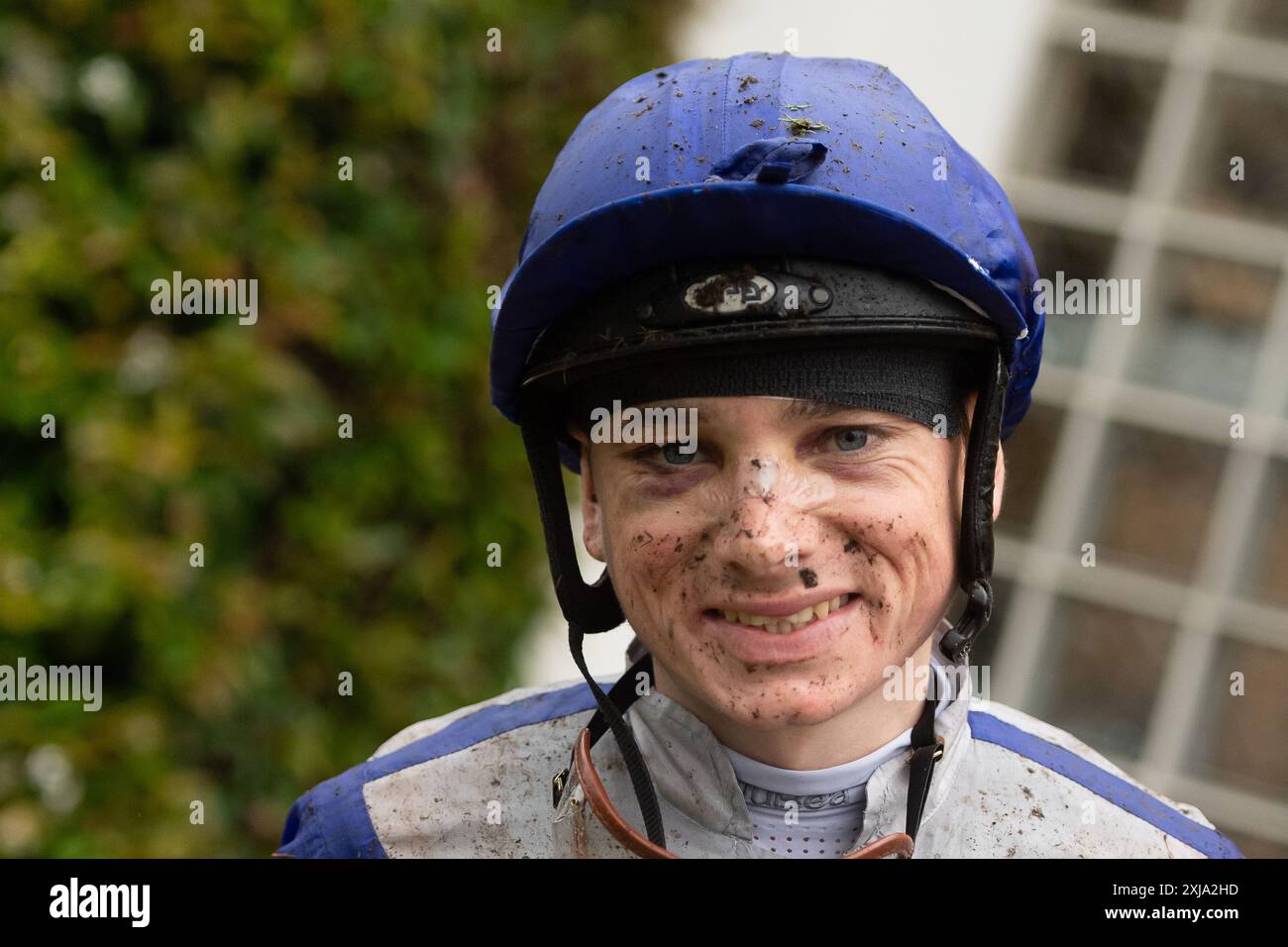Windsor, Berkshire, UK. 15th July, 2024. A muddy but smiling Jockey ...