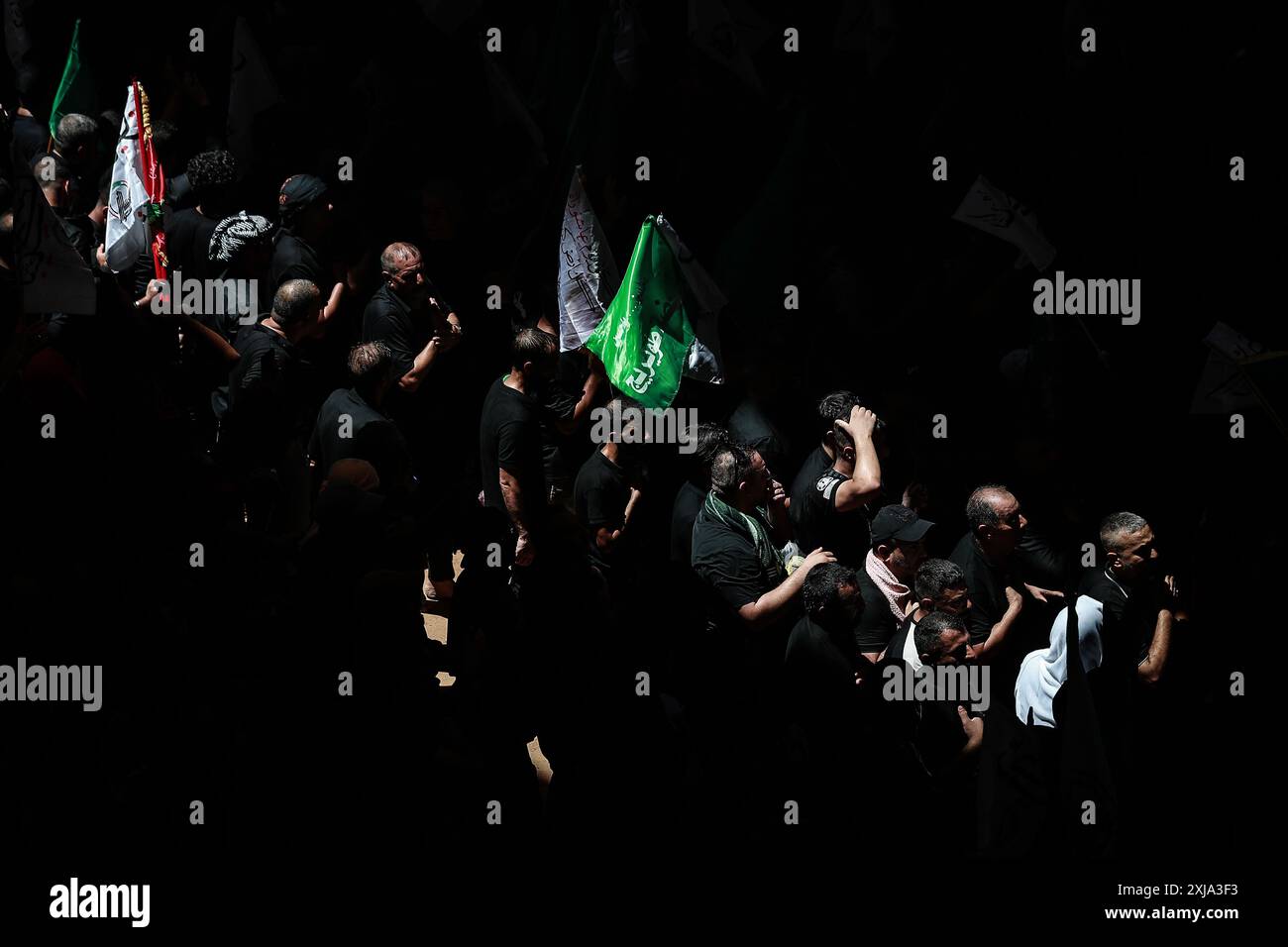 Karbala, Iraq. 17th July, 2024. Iraqi Shiite Muslims take part in a ...
