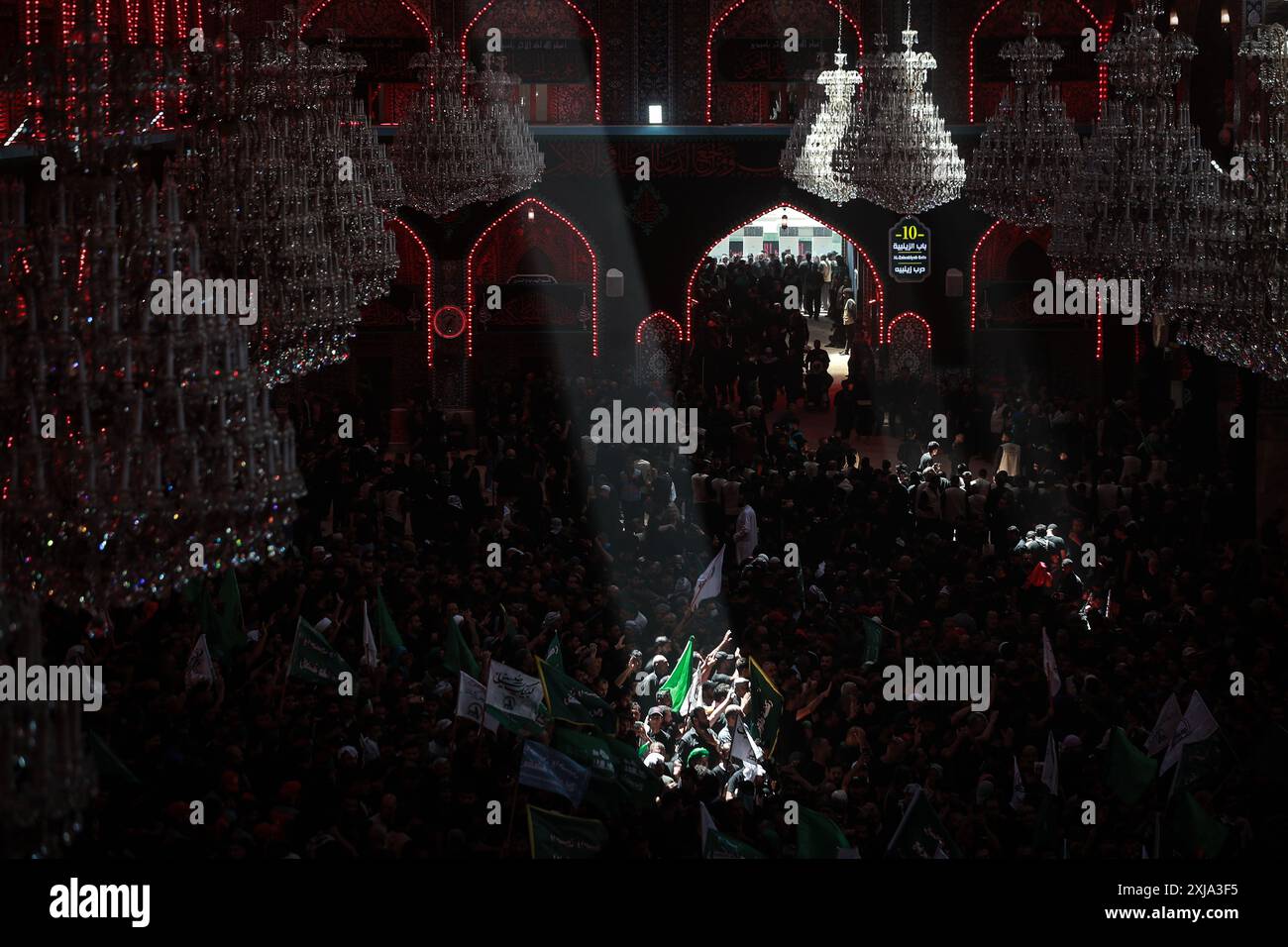 Karbala, Iraq. 17th July, 2024. Iraqi Shiite Muslims take part in a ...