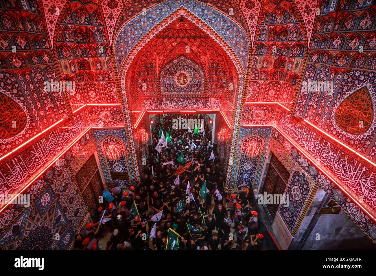 Karbala, Iraq. 17th July, 2024. Iraqi Shiite Muslims take part in a ...