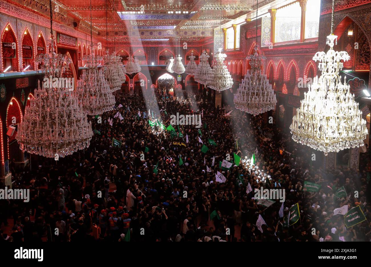 Karbala, Iraq. 17th July, 2024. Iraqi Shiite Muslims take part in a ...