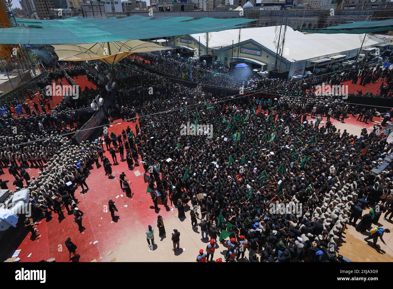 Karbala, Iraq. 17th July, 2024. Iraqi Shiite Muslims take part in a ...