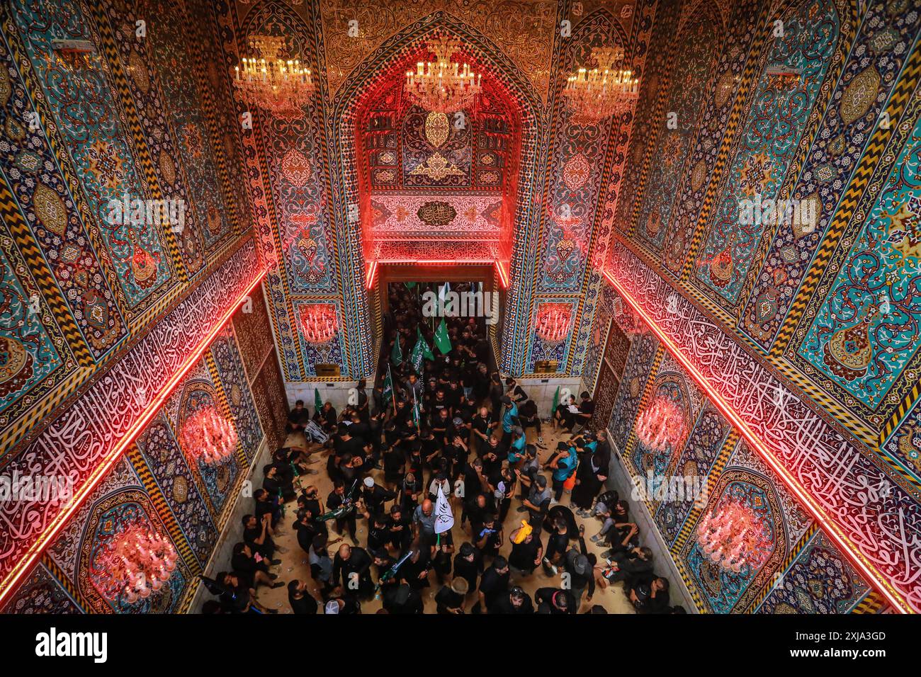 Karbala, Iraq. 17th July, 2024. Iraqi Shiite Muslims take part in a ...
