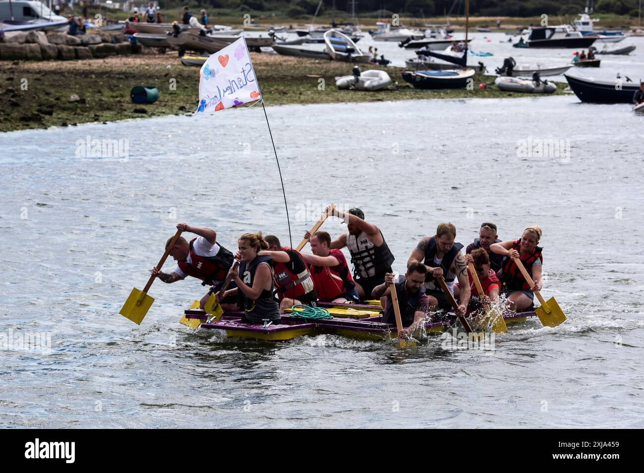 Mudeford RNLI fun day, charity event raft race in the harbour Stock ...