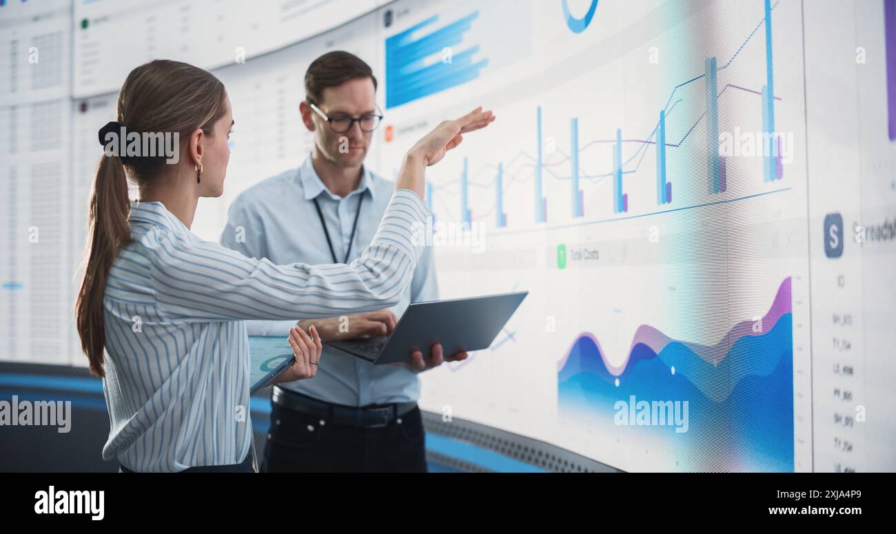 Caucasian Male And Female Data Scientists With Laptop And Tablet ...