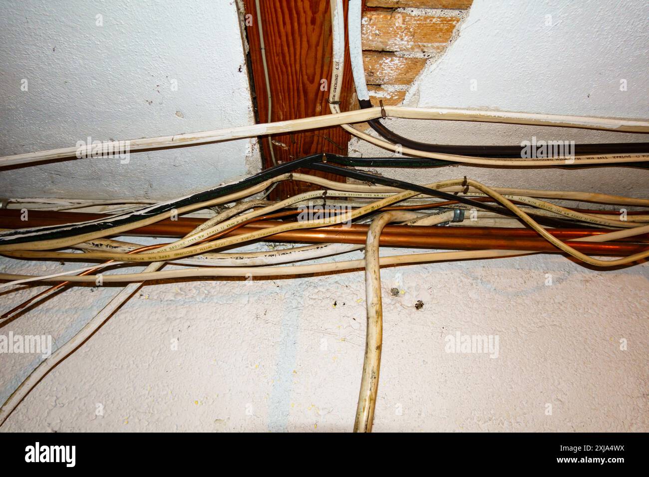 Exposed home electrical wires in basement Stock Photo - Alamy
