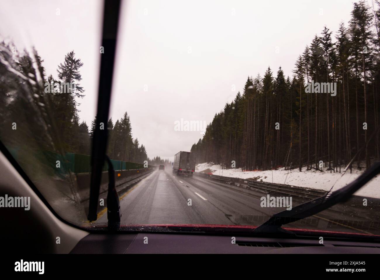 Driver's perspective through windshield of winter highway with semi ...