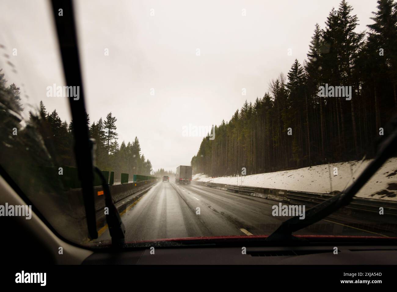 Driver's perspective through windshield of winter highway with semi ...