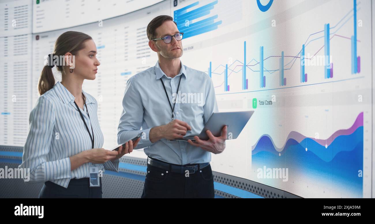 Male And Female Data Analysts Discussing New Locations For Business In ...