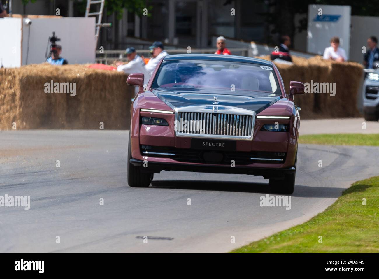 2024 Rolls-Royce Spectre car driving up the hill climb track at the ...