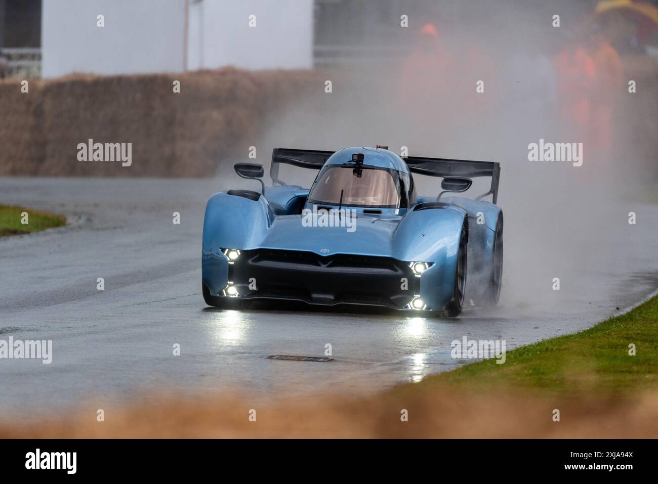 McMurtry Speirling Pure electric race car driving up the wet hill climb track at the Goodwood ...