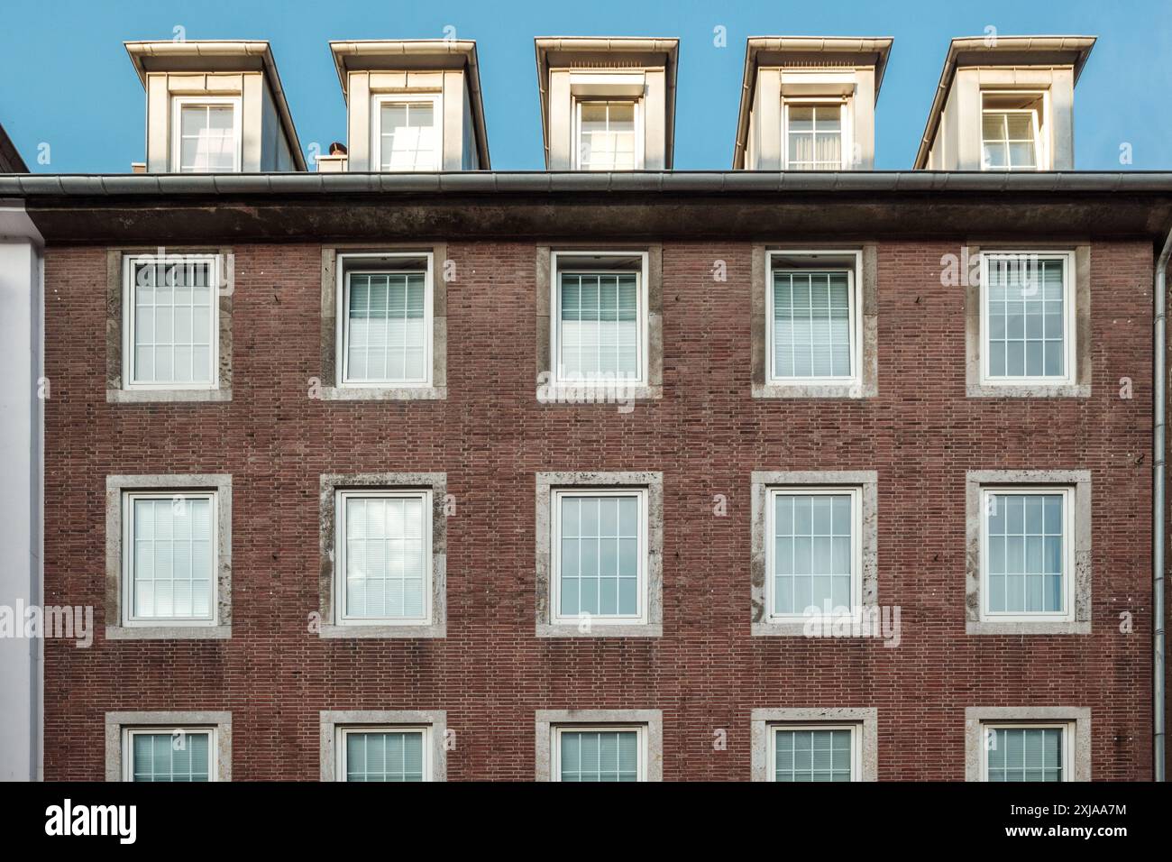 Modern Brick Building Facade with Windows and Dormers Stock Photo - Alamy