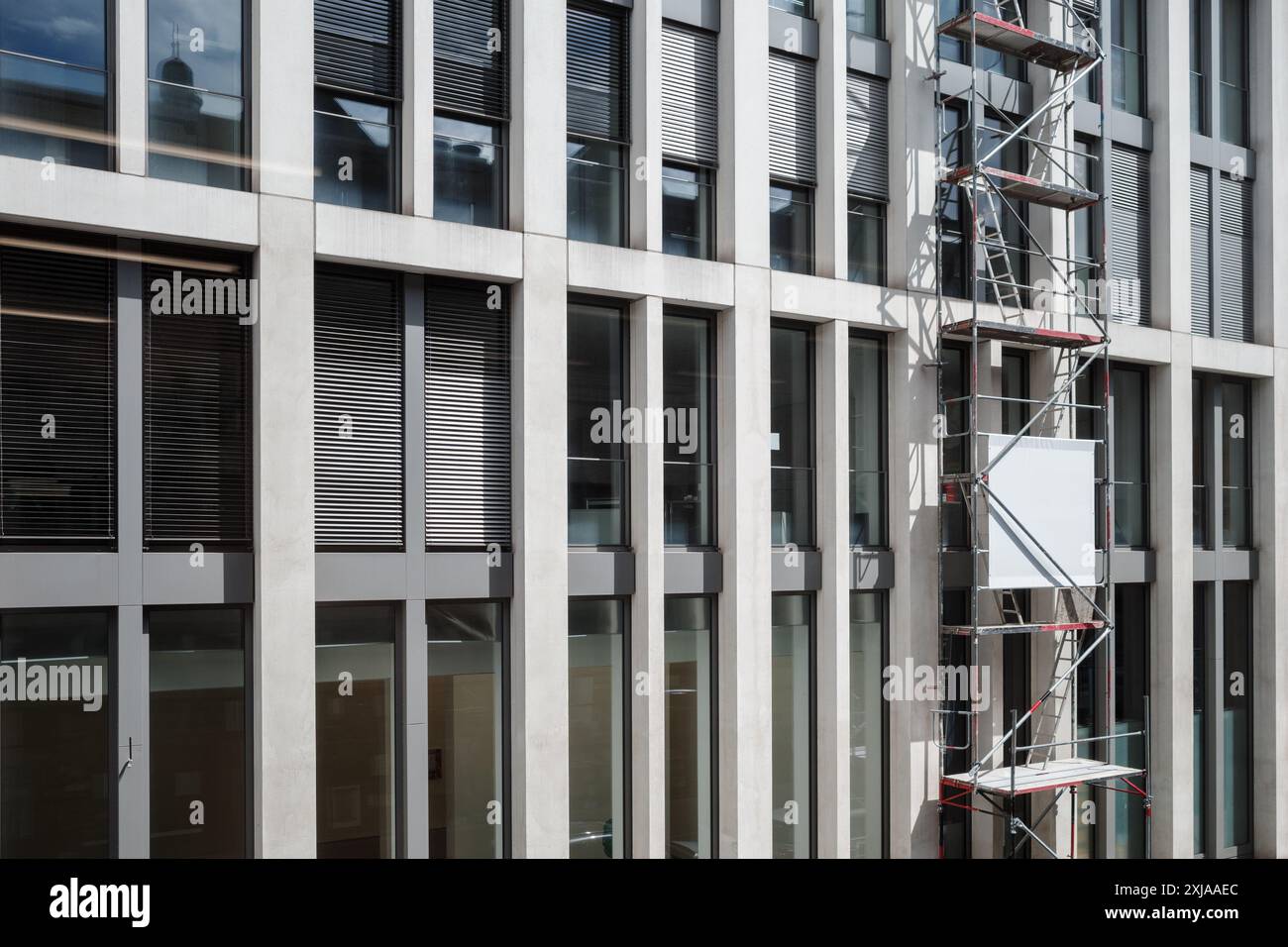 A contemporary office building facade with large windows and vertical ...