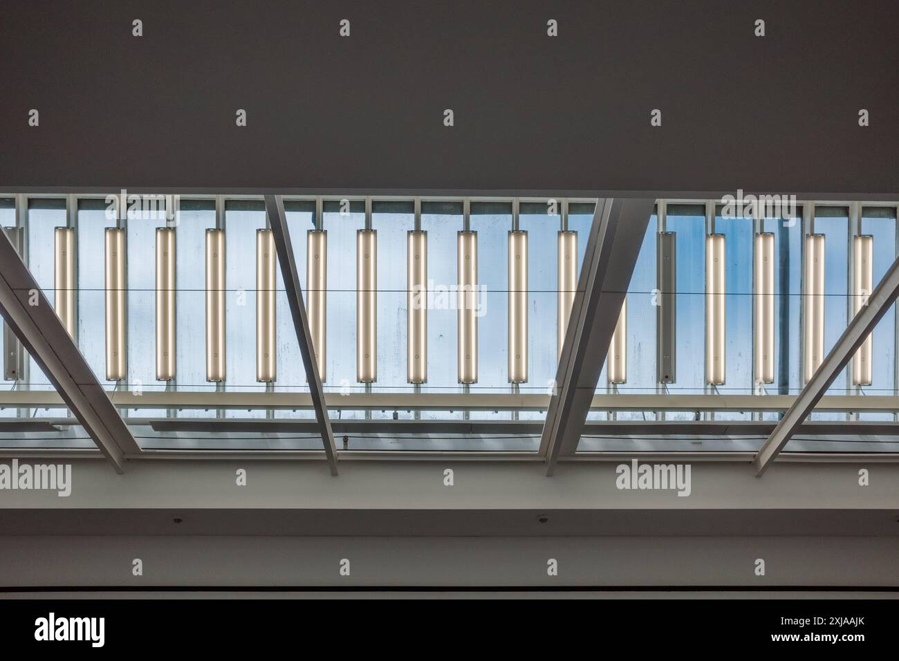 A close-up view of a modern ceiling featuring a row of fluorescent ...