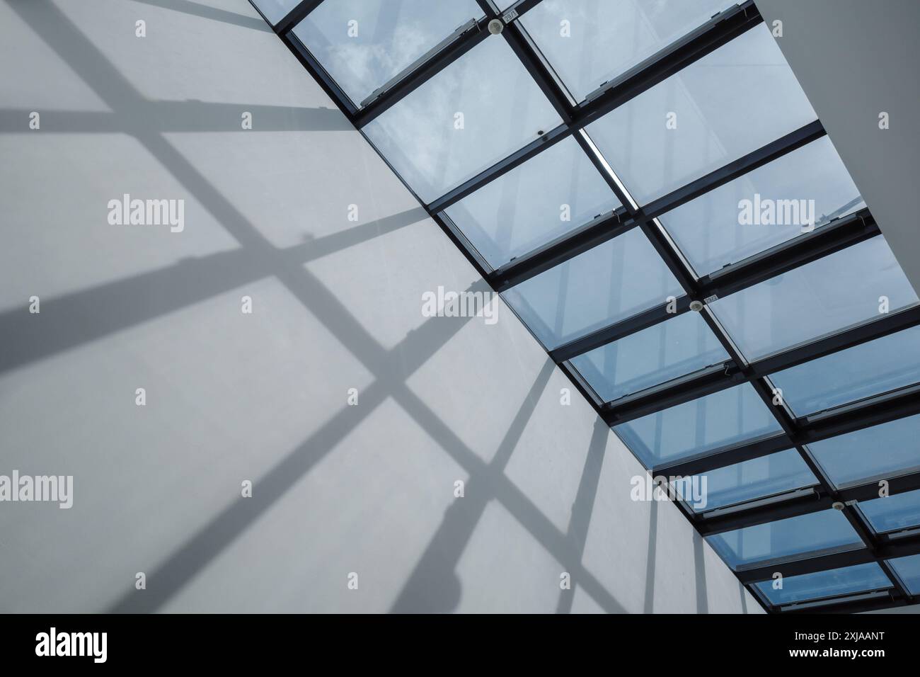 modern skylight composed of a grid of glass panels set within a sleek ...