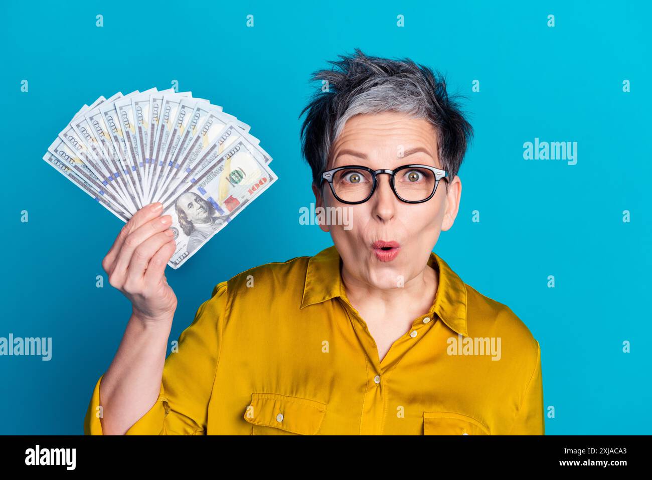 Photo of confident shocked lady dressed shirt glasses rising cash fan ...