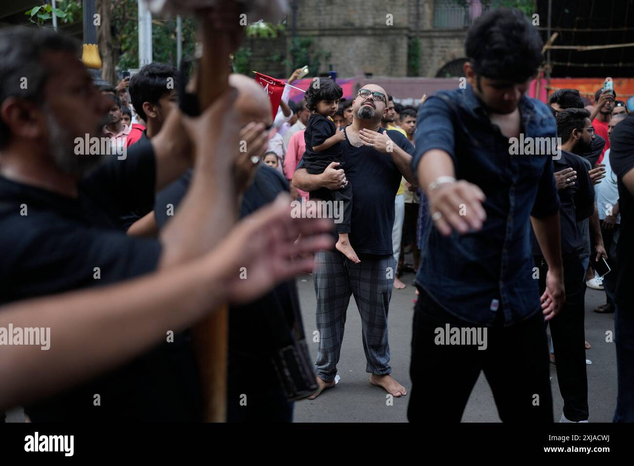 Shiite Muslims mourn by beating their chests during a Muharram ...