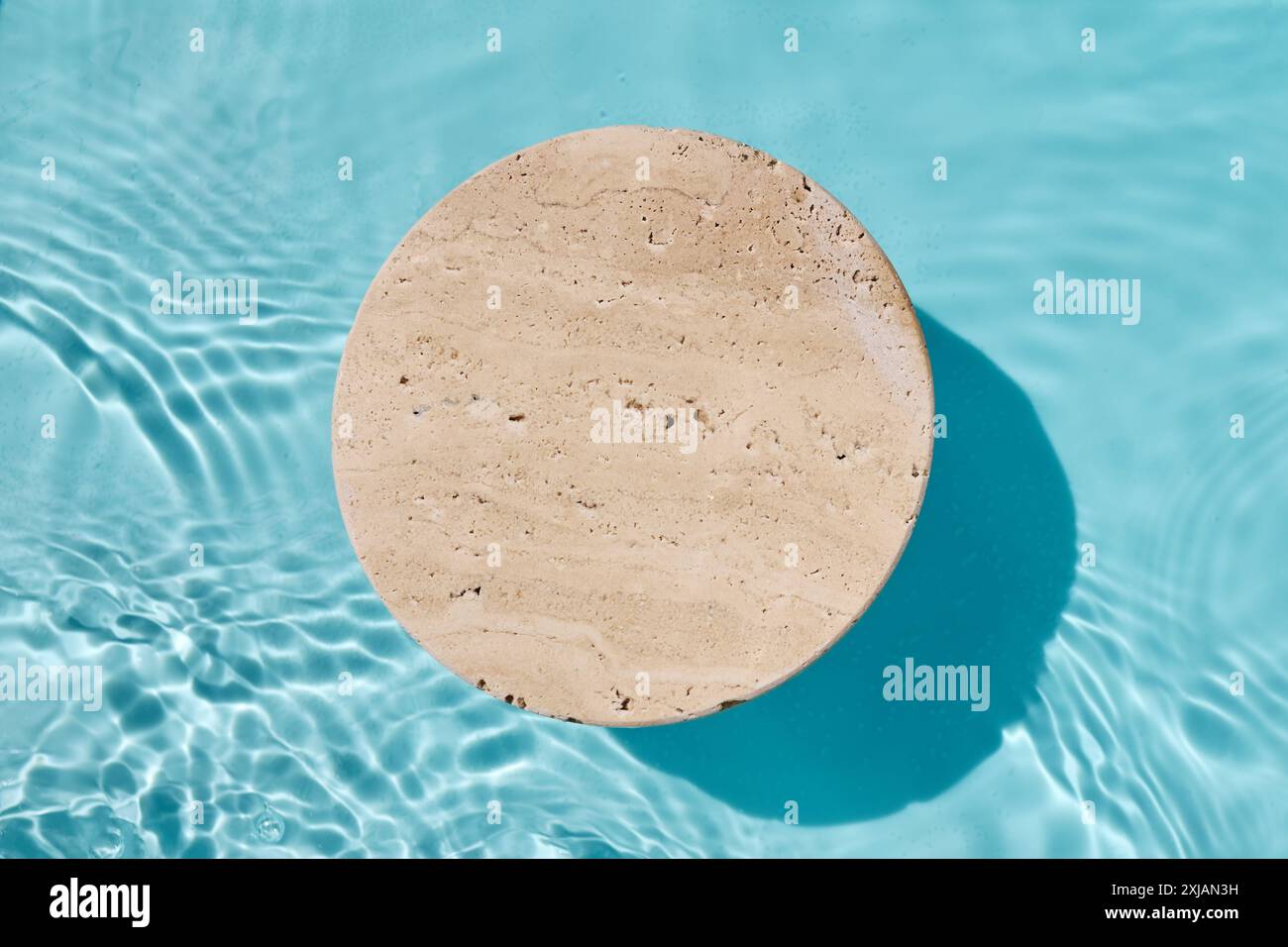 Podium for cosmetic presentation. A round stone slab floating on clear ...